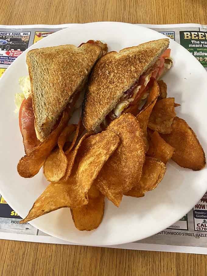 A proper BLT with golden potato wedges proves that sometimes lunch sneaks onto the breakfast menu with spectacular results.