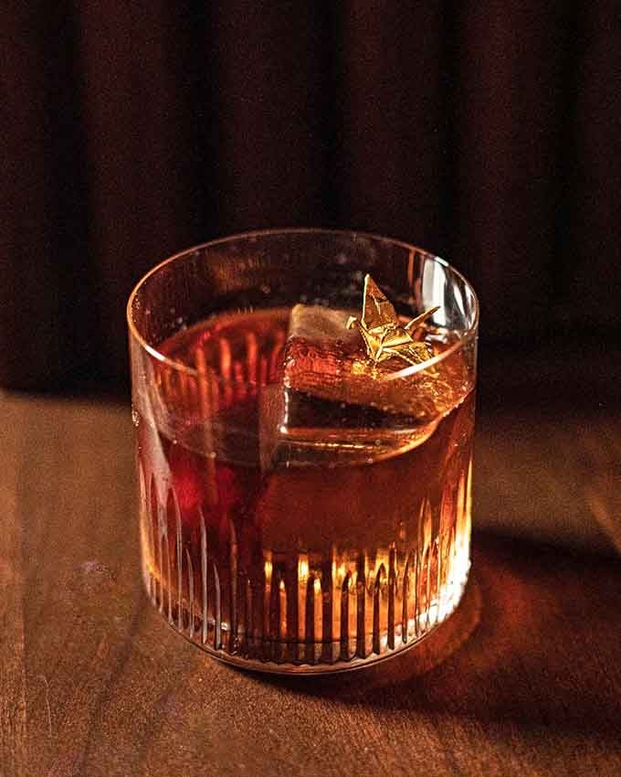 The Golden Goose glows like liquid sunshine, served with a garnish that makes you pause before that first perfect sip.