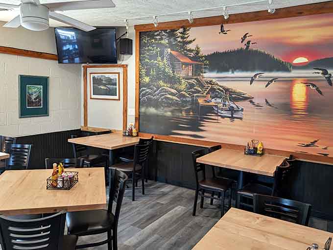 Sunset mural transports diners to a lakeside cabin while they devour plates of authentic smoked meats.