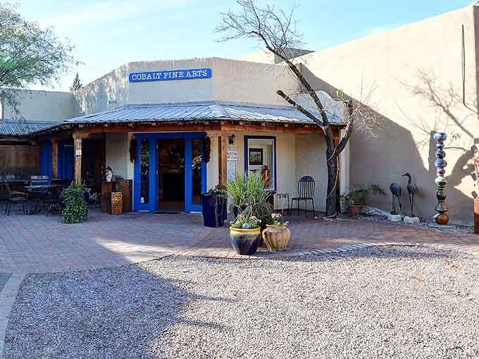 Cobalt blue trim against cream walls whispers sophistication while potted plants add homey desert charm.