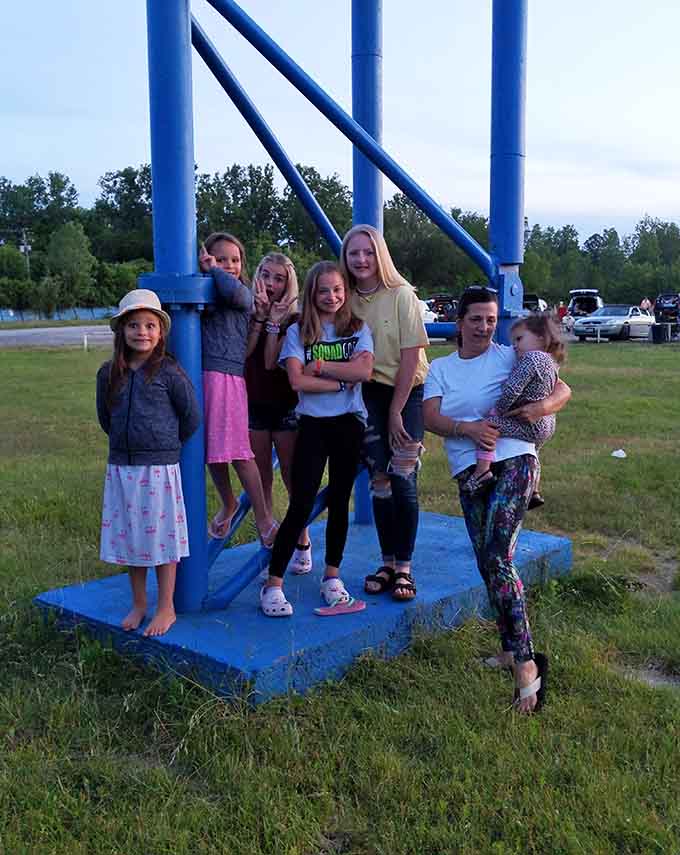 Kids climbing the playground equipment between films, burning energy before the second feature starts at ten-thirty.