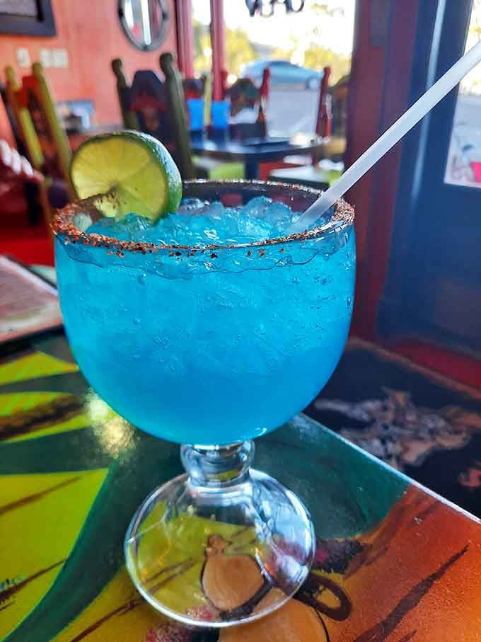This electric blue margarita looks like it contains liquid happiness and possibly the secret to eternal joy in a glass.