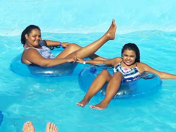 Floating peacefully on inner tubes, blissfully unaware that someone's about to create a tidal wave from the slide.