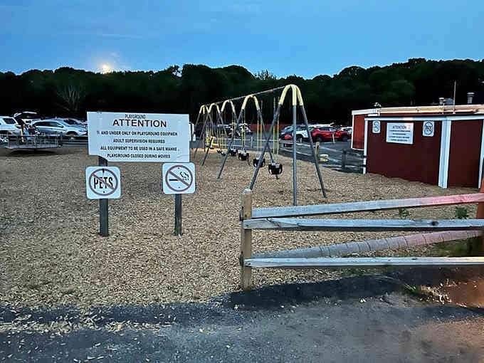The playground where kids burn energy before showtime, because tired children make peaceful movie companions always.