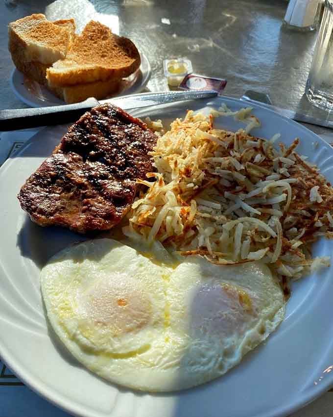 A thick pork chop with hash browns and sunny eggs delivers the breakfast-for-dinner energy we all need in our lives right now.