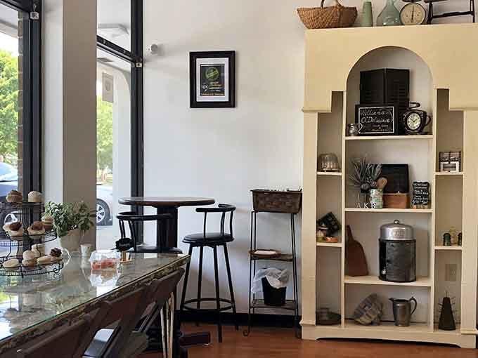 Natural light, cozy seating, and a shelf displaying treasures, this bakery understands the assignment perfectly.