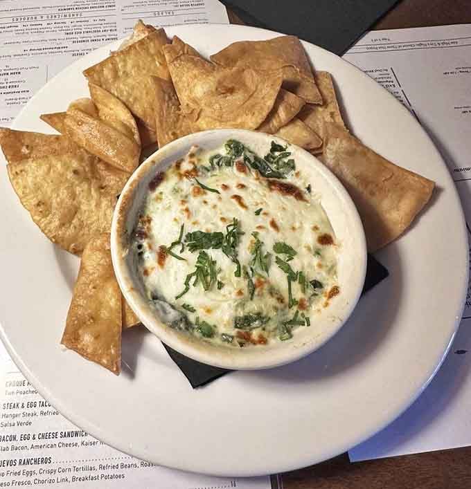 Spinach artichoke dip arrives bubbling hot with chips and flatbread, making sharing an exercise in willpower and negotiation.