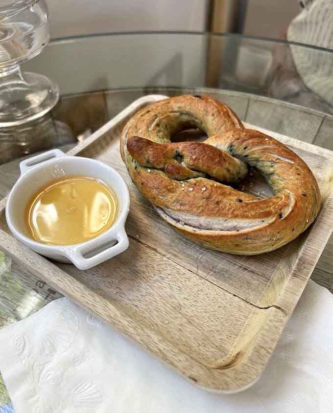 Golden-brown pretzel twisted into perfection with mustard for dipping is comfort food elevated to an art form worth celebrating.