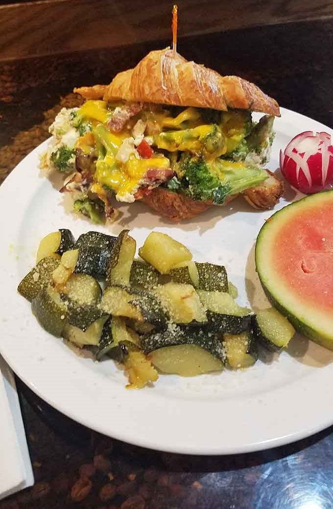 The breakfast croissant sandwich is flaky, eggy perfection that makes early mornings worth celebrating with every bite.