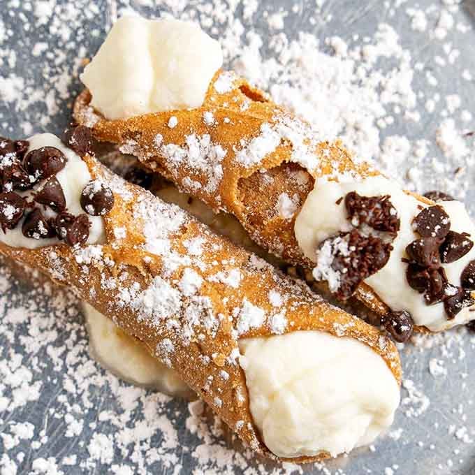 Cannoli filled with sweet ricotta and chocolate chips, proving that Italians really understood the assignment with desserts.