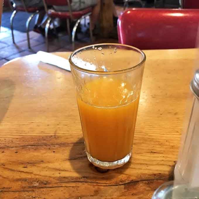 Fresh orange juice in a simple glass tastes like sunshine decided to take liquid form this morning.