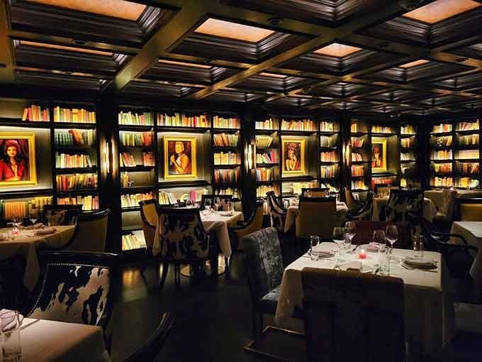 Floor-to-ceiling bookshelves create an intimate library atmosphere where the only thing you'll be checking out is the incredible menu.