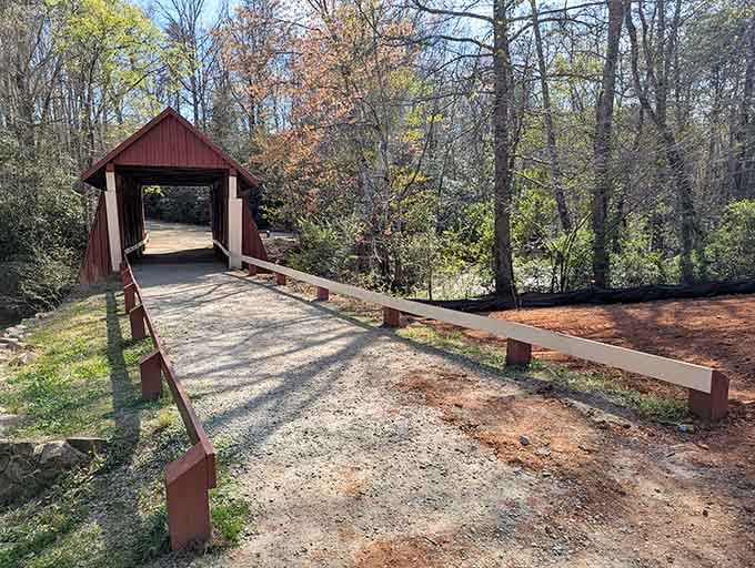 Red wooden beams frame the entrance to this charming bridge, inviting you to step back into simpler times.