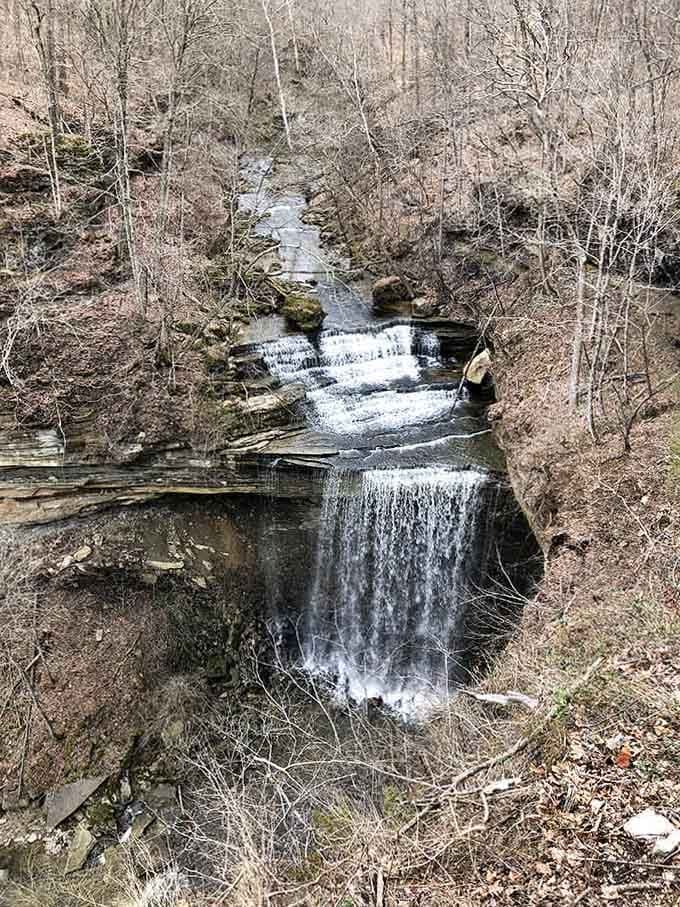Multiple cascades tumble down layered rock formations like nature's own staircase, each step more beautiful than the last.