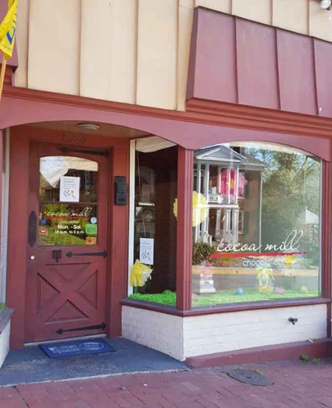 Cheerful pink and cream facade with barn-style door – chocolate heaven disguised as a storybook cottage.