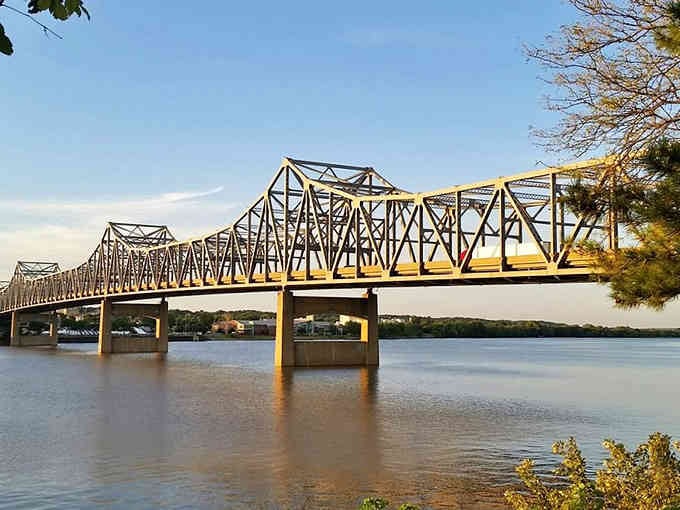 Steel bridge spans stretch across the mighty Mississippi like giant erector sets connecting Illinois to adventure beyond.