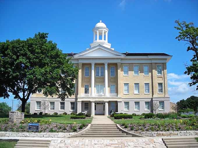 This stately building stands like a Greek Revival masterpiece, its white cupola gleaming against impossibly blue skies.