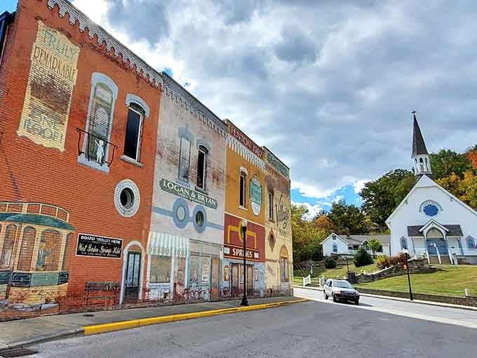 Ghost signs fade on brick walls while a white church watches over French Lick's quiet streets below.