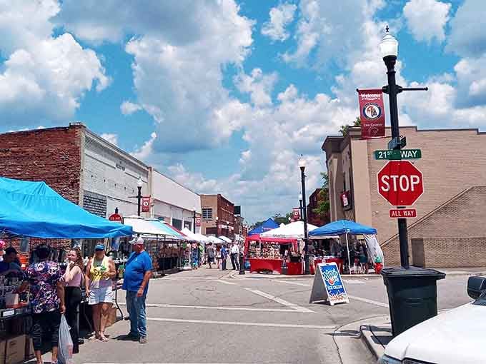 Blue tents and bustling crowds transform the street into a vibrant marketplace where neighbors become friends over fresh produce.