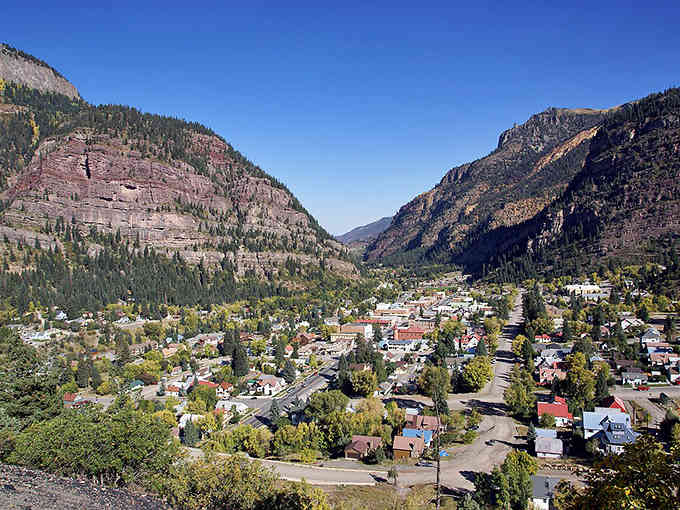 Autumn colors splash across the hillsides surrounding this canyon town where every season paints a different masterpiece on the mountains.