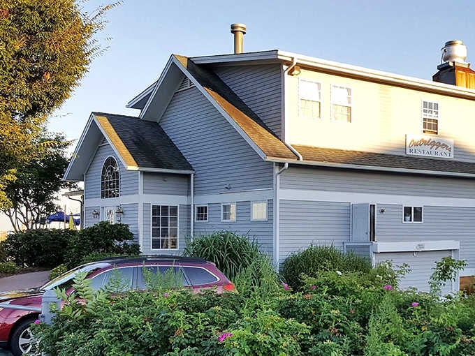 Classic white clapboard architecture frames the entrance, hinting at the refined waterfront experience waiting inside diners.
