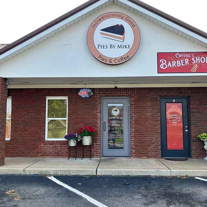 Fresh flowers and welcoming doors hint at the "irresistibly good" pies waiting just beyond this charming brick entrance.
