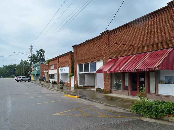 Rain-slicked streets reflect stormy skies above brick buildings that have weathered countless similar days before.