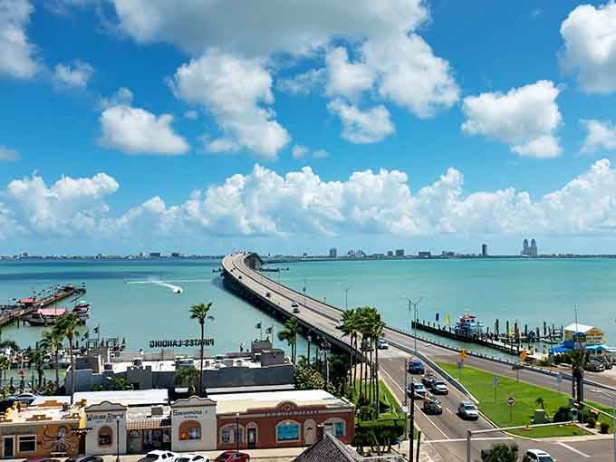 That causeway stretches across turquoise water toward adventures, with palm trees swaying their tropical welcome dance.