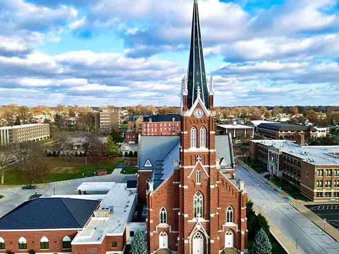 That soaring brick steeple reaches skyward like it's trying to have a conversation with the clouds themselves.