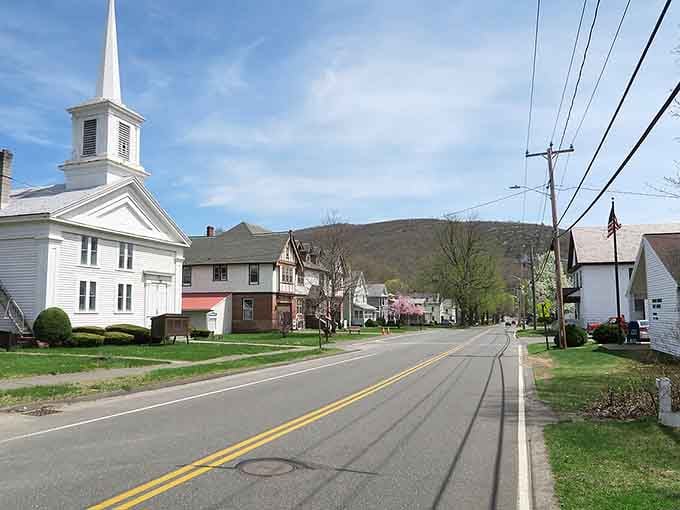 Open roads stretch past white churches and green lawns, embodying that peaceful small-town life we all dream about.