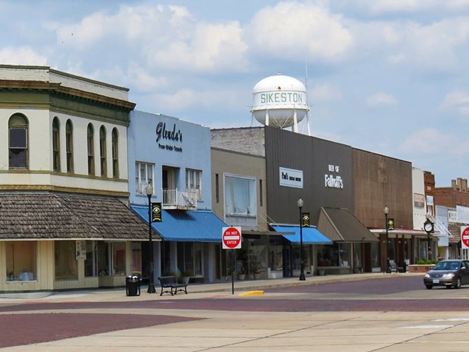 That water tower announces the town's name like a lighthouse guiding travelers to safe harbor below.