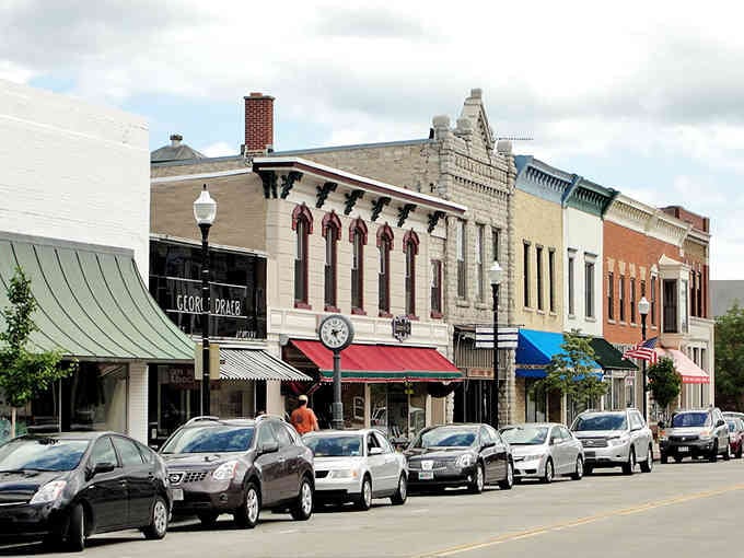 Historic storefronts create a colorful patchwork along main street where local businesses thrive and shopping feels personal, not corporate or rushed.