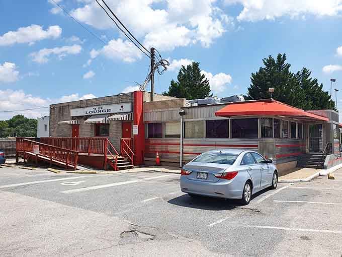 The vintage diner car with its distinctive red canopy sits like a chrome jewel in the parking lot.