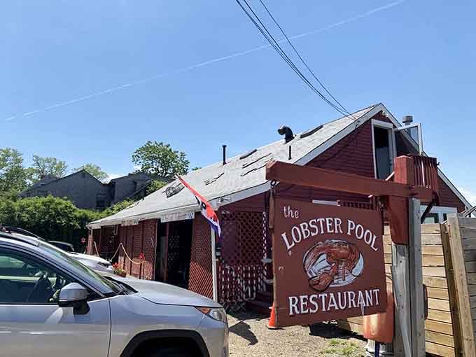 This charming red building perched by the ocean looks like it sailed straight out of a classic New England postcard.