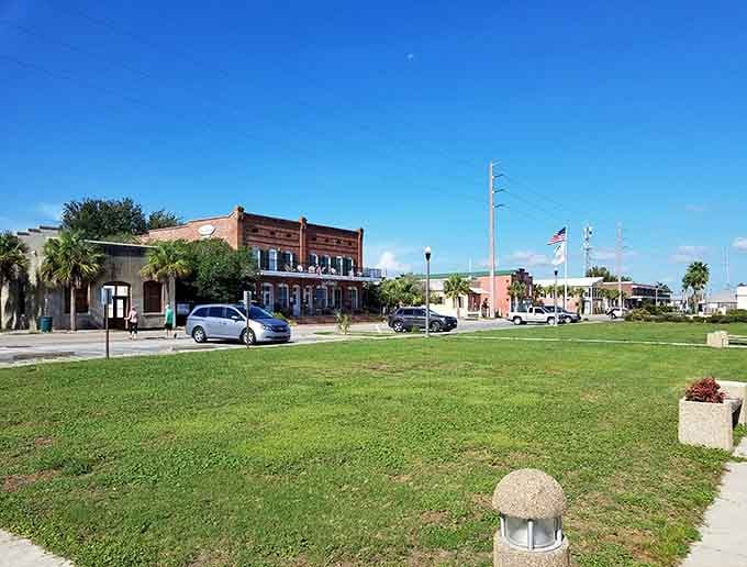 Sunny Apalachicola scene features historic buildings, open green space, and coastal charm, inviting visitors to relax, stroll, and soak in Florida vibes.