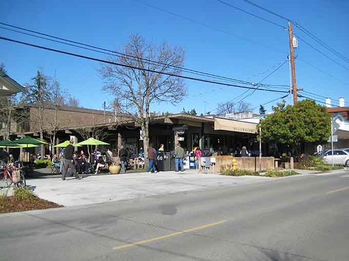 Green umbrellas dot the outdoor seating where locals gather, proving that island life and good coffee go together like, well, islands and ferries.