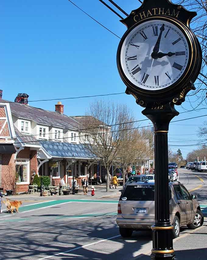 The town clock keeps perfect time above sidewalks where locals stroll and Cape Cod sunshine warms everything.