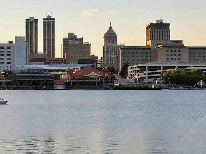 The riverfront skyline glows in golden hour light, proving waterfront views don't require ocean-sized budgets.