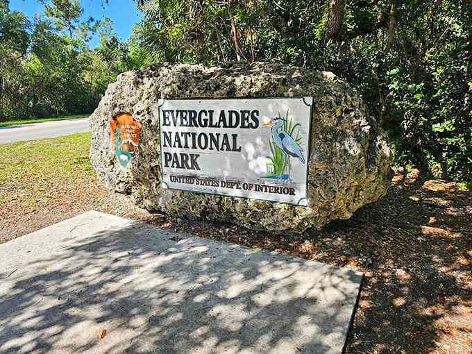 The limestone entrance marker stands weathered and proud, marking the gateway to one of America's most unique ecosystems.