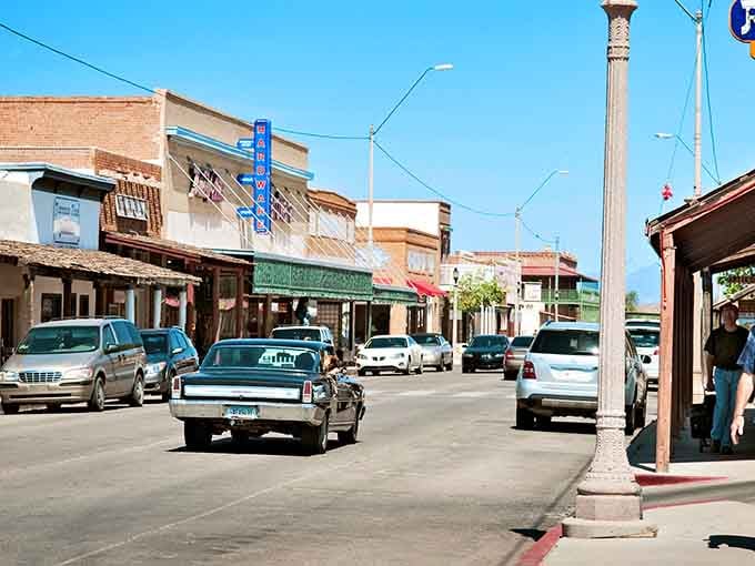 Classic cars cruise past vintage buildings where the 1960s and 1880s somehow coexist in perfect harmony.