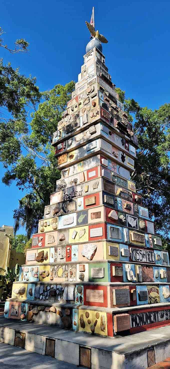Each colorful plaque and rock tells a different American story, stacked together like a geological family reunion under the flag.