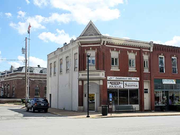 Historic storefronts stand proudly on the corner, their detailed facades proving that beauty and function can coexist perfectly.