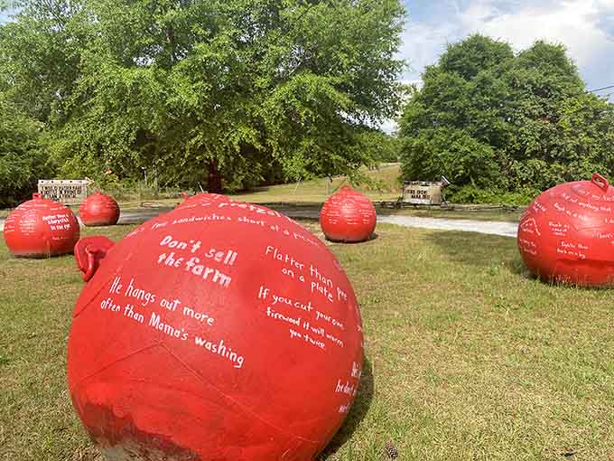 Bright red spheres covered in handwritten wisdom dot the landscape like giant fortune cookies made of concrete.