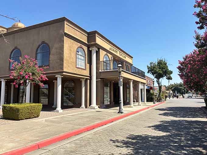 Classical columns frame sunny sidewalks where Mediterranean-style architecture brings unexpected elegance to the Central Valley landscape.