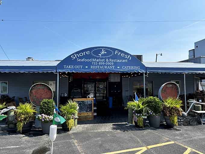 The cheerful blue awning and potted plants create an inviting entrance to a market-restaurant combo that locals treasure year-round.