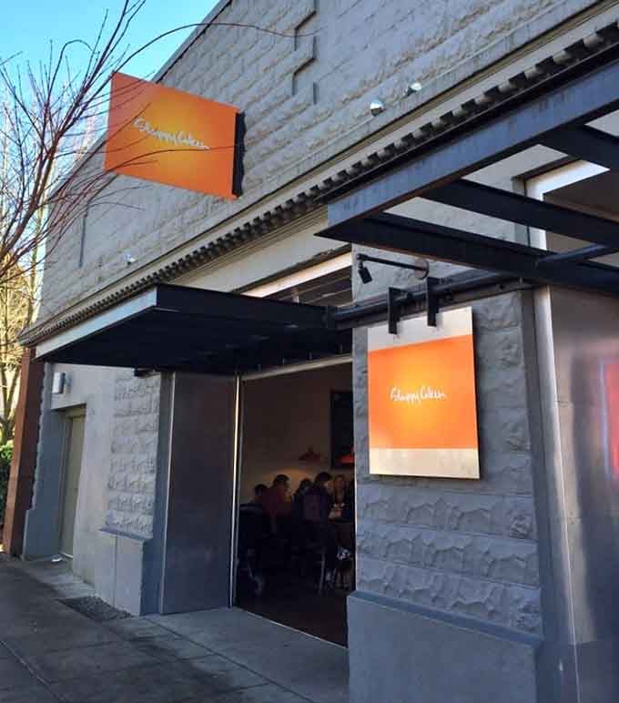 Evening light catches the geometric awning perfectly, framing an entrance where pancake dreams and maple syrup fantasies come true.