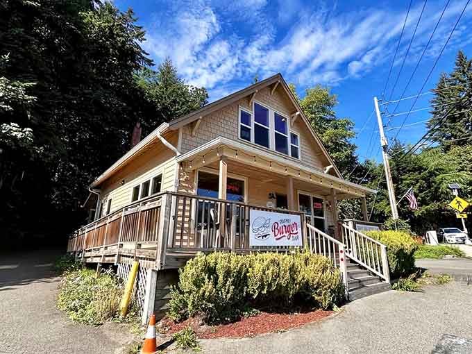 Bright blue skies frame this cozy burger haven where the porch railing has witnessed countless burger victories and defeats.
