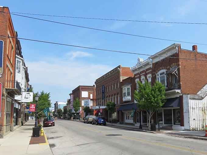 Summer greenery softens the historic storefronts along this quiet street where time moves at a gentler pace.