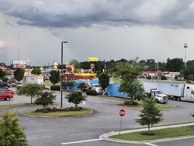 Storm clouds gather over everyday commerce, where life happens at the intersection of necessity and neighborliness.