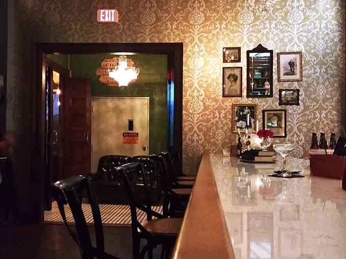 Ornate wallpaper and vintage frames transform simple counter seating into something worthy of a design magazine spread.
